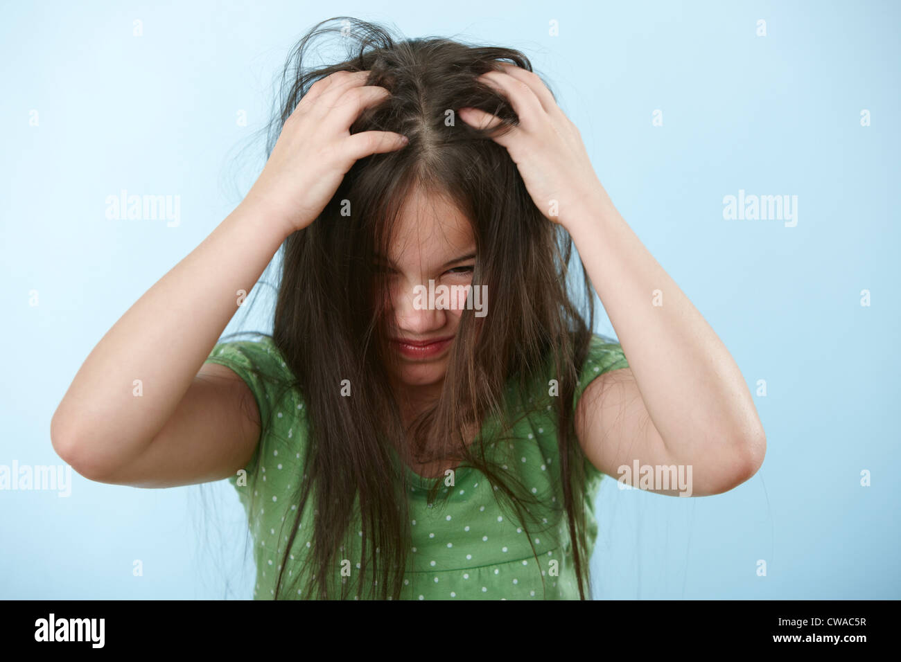 Girl scratching head Stock Photo - Alamy