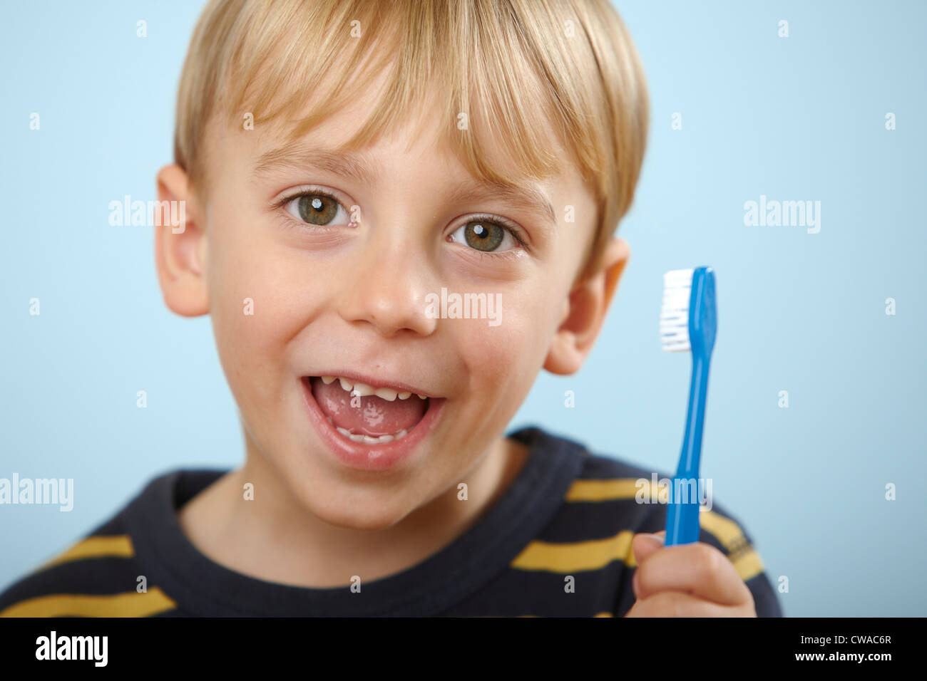 Boy holding toothbrush Stock Photo - Alamy