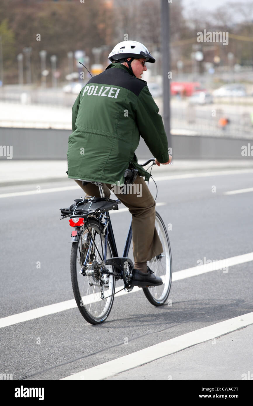 Policeman riding a bicycle Stock Photo - Alamy