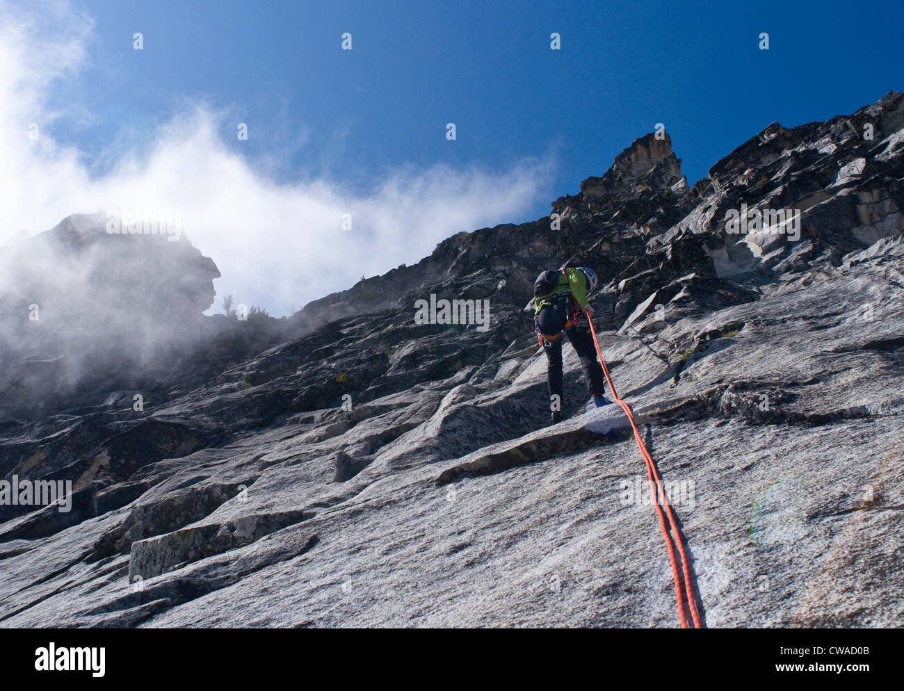 Climber rappelling rock wall, Mount Berge, Cascade Range, Washington ...
