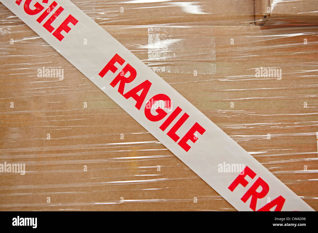 Cardboard box with parcel tape saying fragile Stock Photo - Alamy