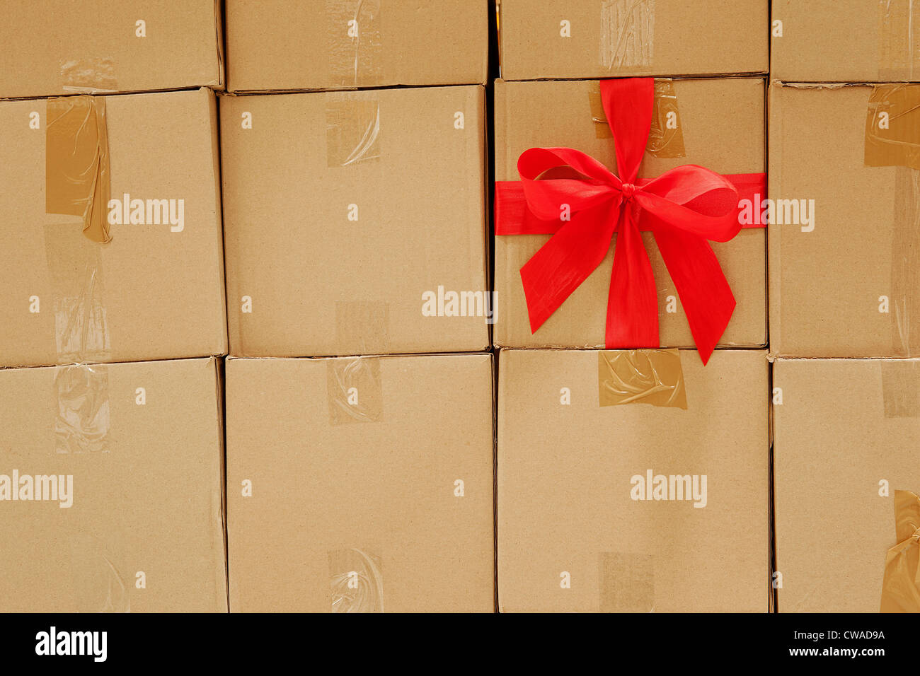 Cardboard box with red bow Stock Photo - Alamy