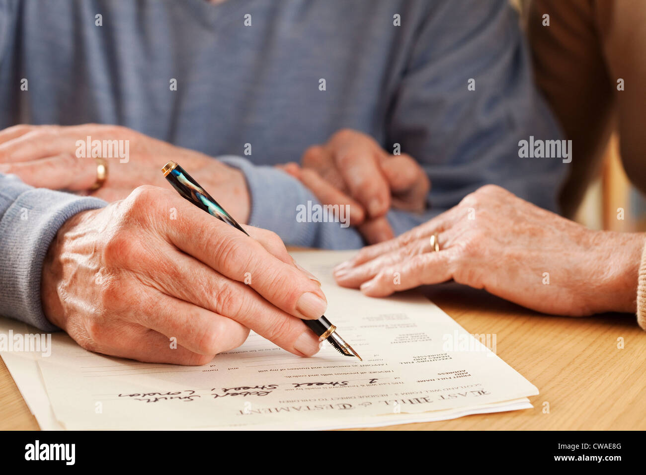 Senior man signing will Stock Photo - Alamy