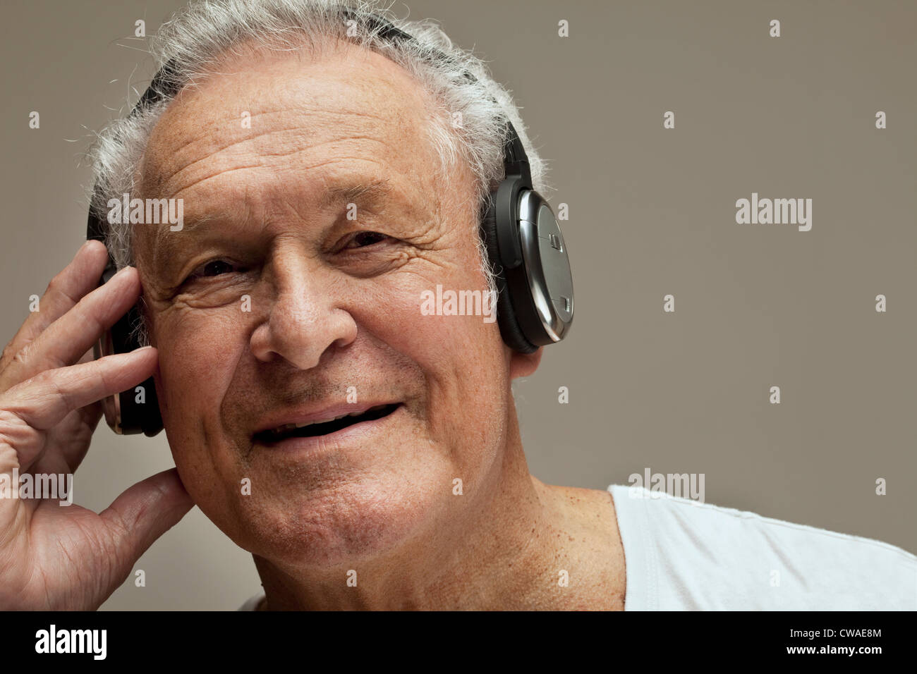 Senior man wearing earphones hi-res stock photography and images - Alamy