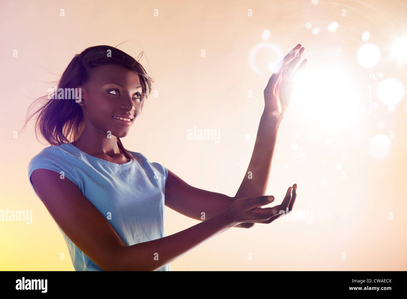Teenage girl touching lights Stock Photo - Alamy