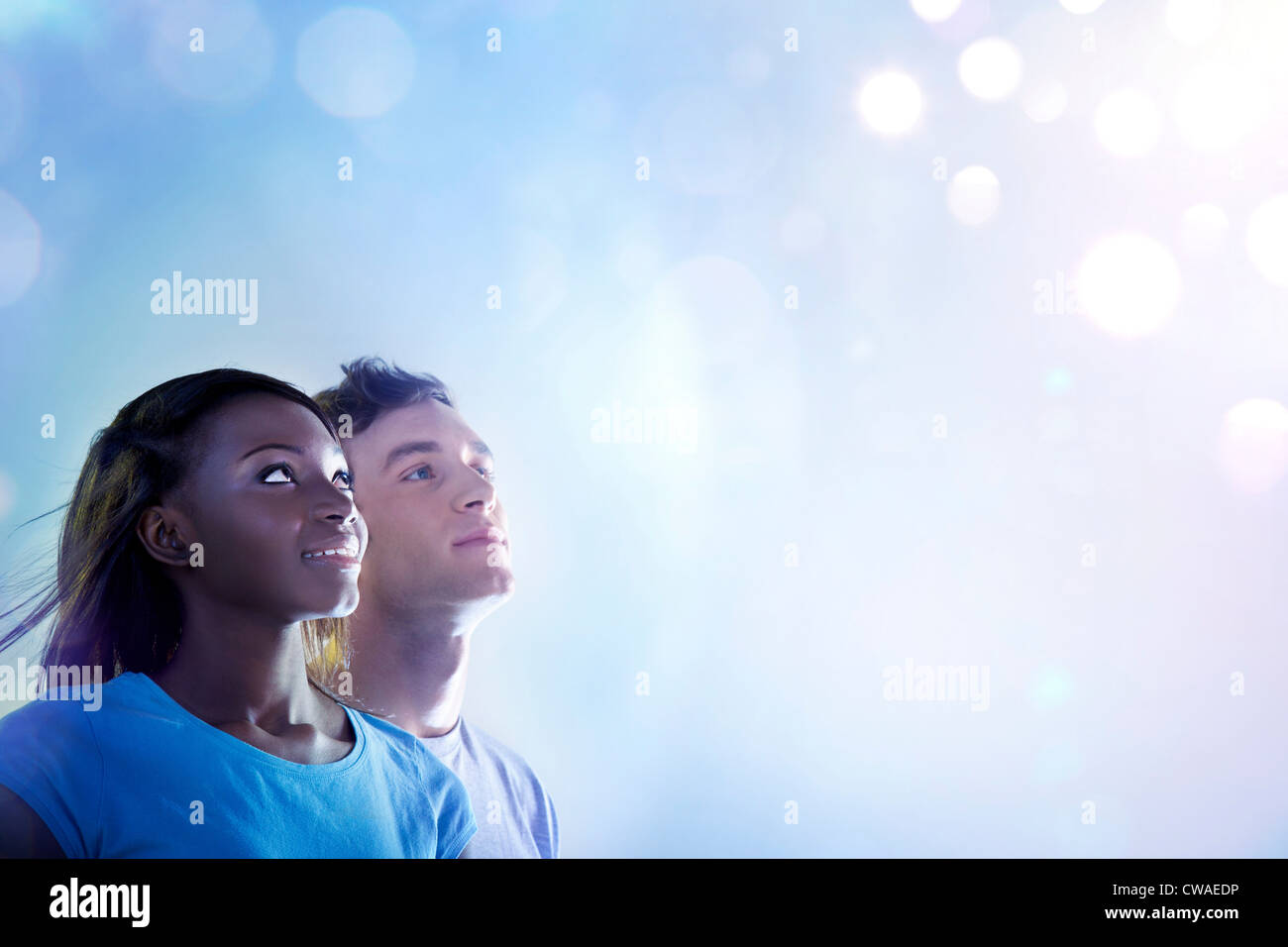 Young people looking up at light Stock Photo - Alamy