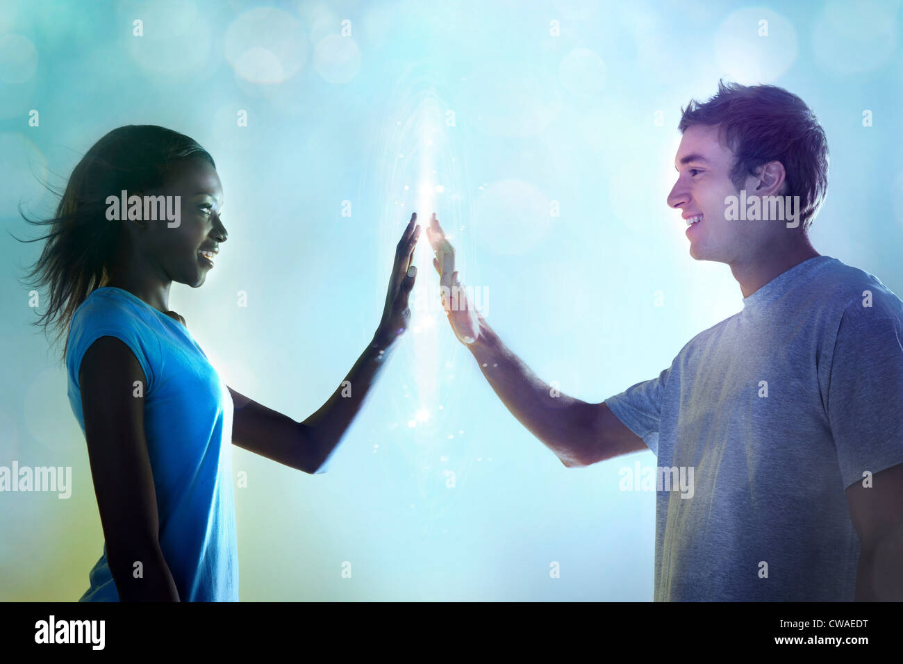 Young people touching light Stock Photo - Alamy