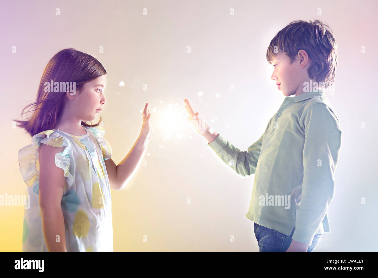 Girl and boy touching bright lights Stock Photo - Alamy