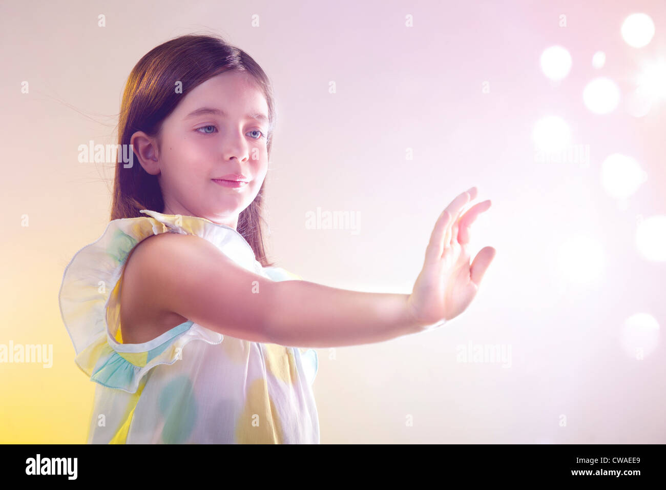 Girl reaching out to lights Stock Photo - Alamy