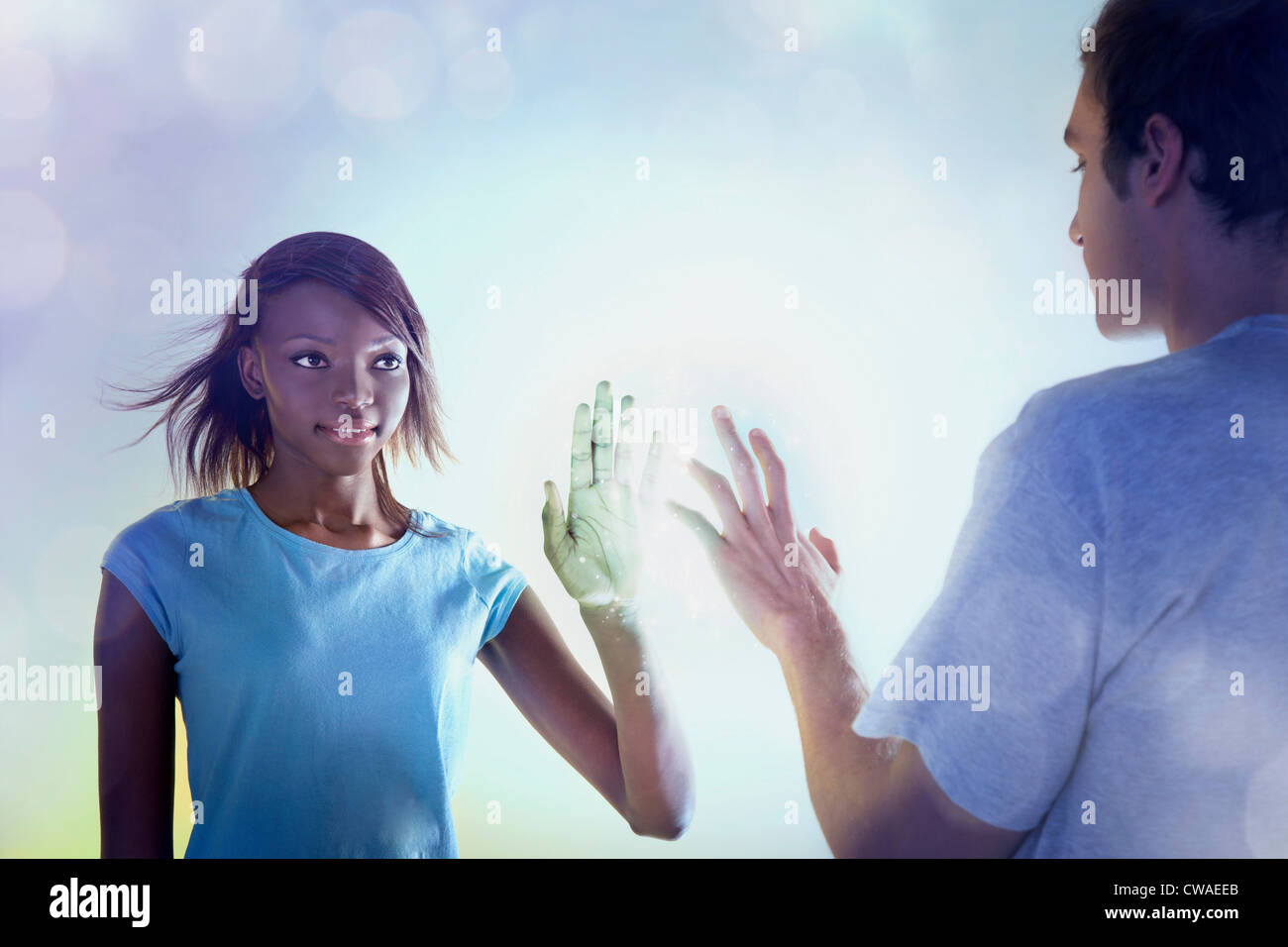 Young people touching light Stock Photo - Alamy
