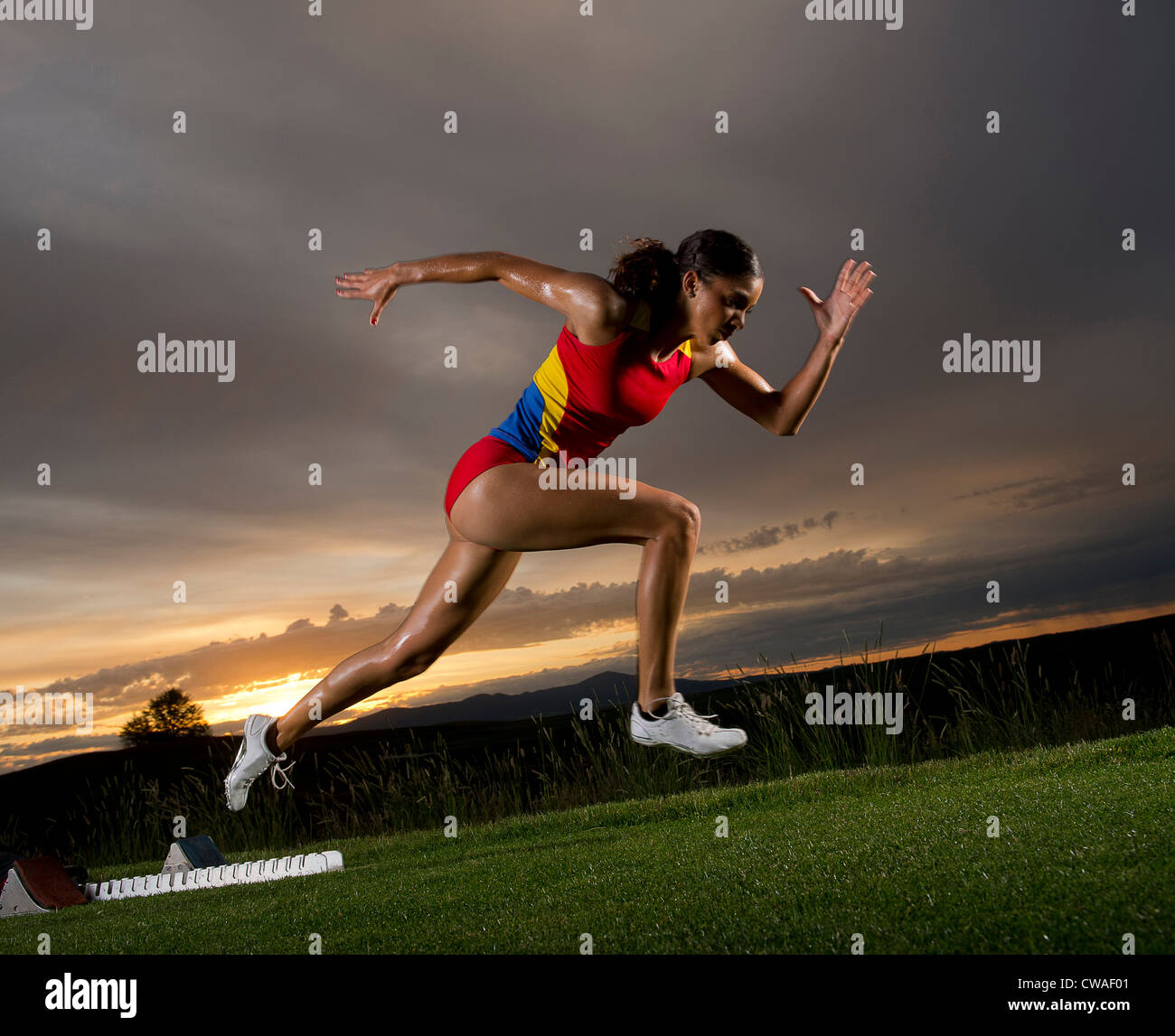 Woman sprinter leaving starting blocks hi-res stock photography and ...