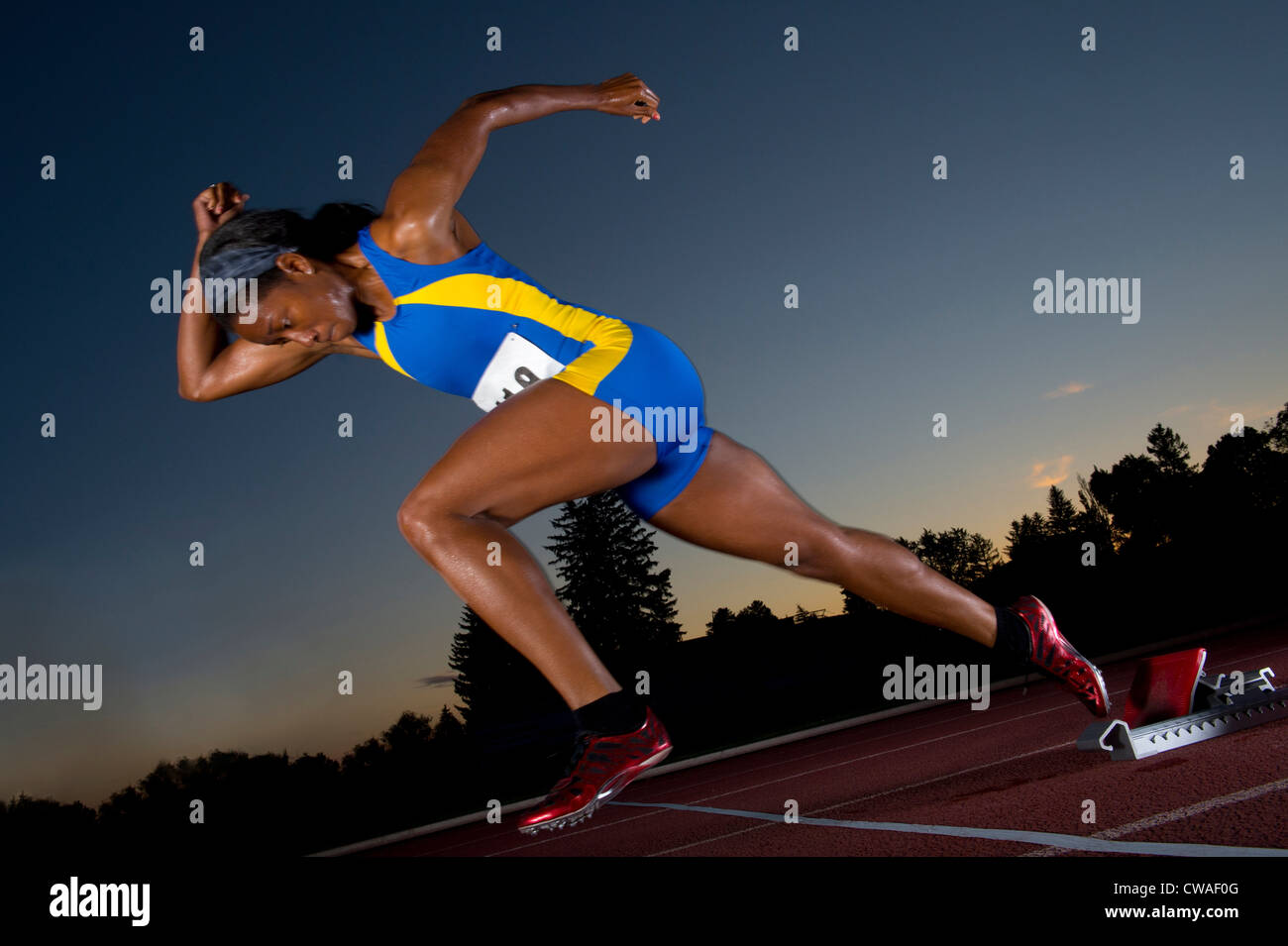 Woman Sprinter Leaving Starting Blocks Stock Photos & Woman Sprinter ...