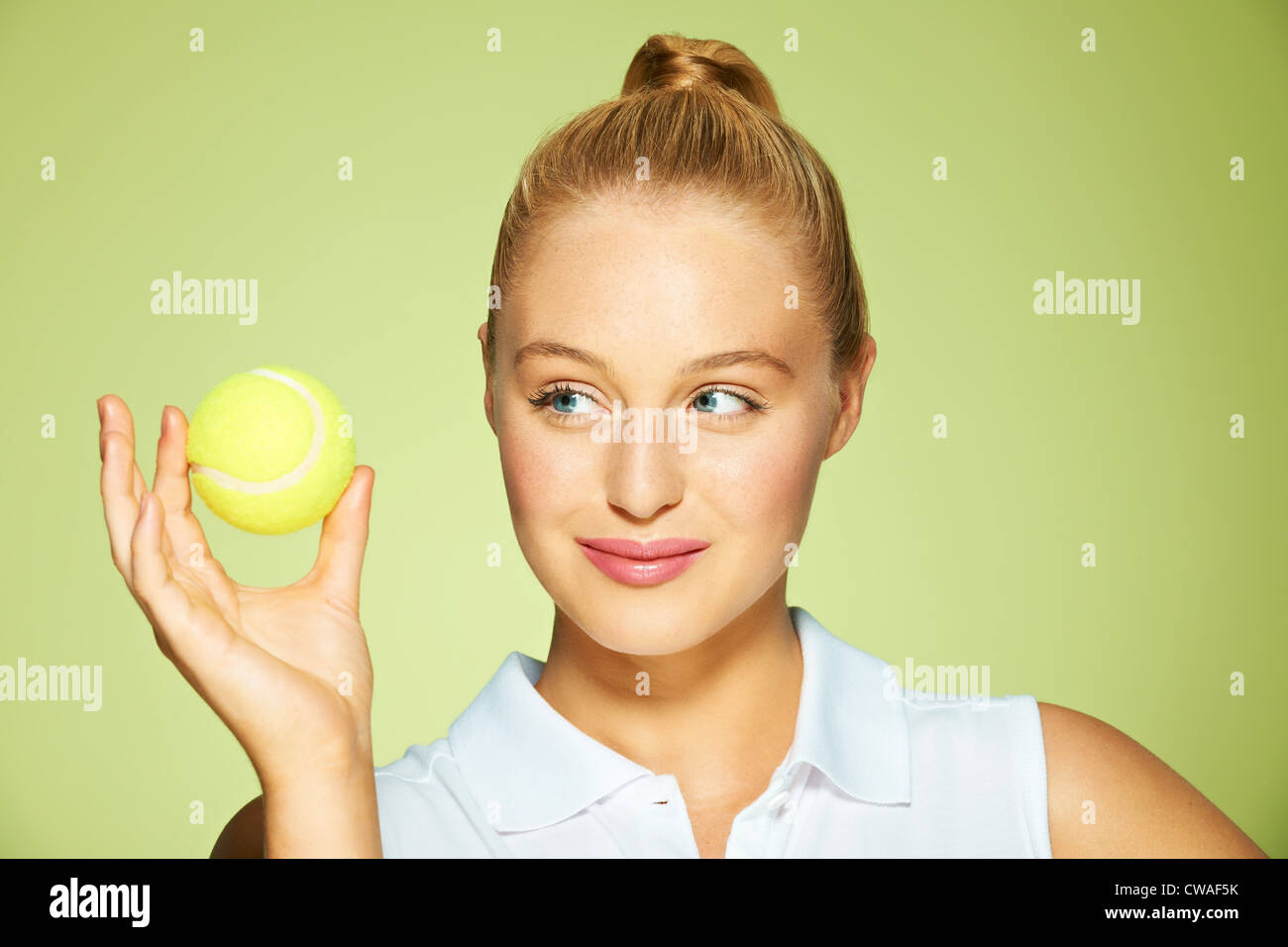 Young woman holding tennis ball Stock Photo - Alamy
