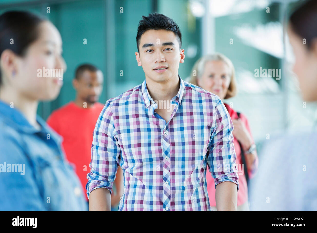 Young man in crowd Stock Photo - Alamy