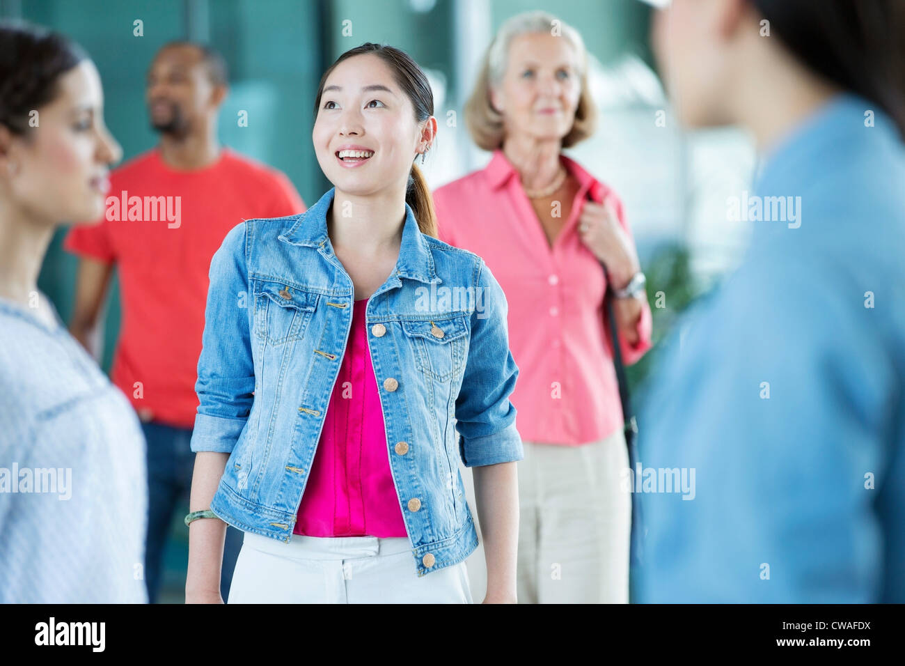 Young woman in crowd Stock Photo - Alamy