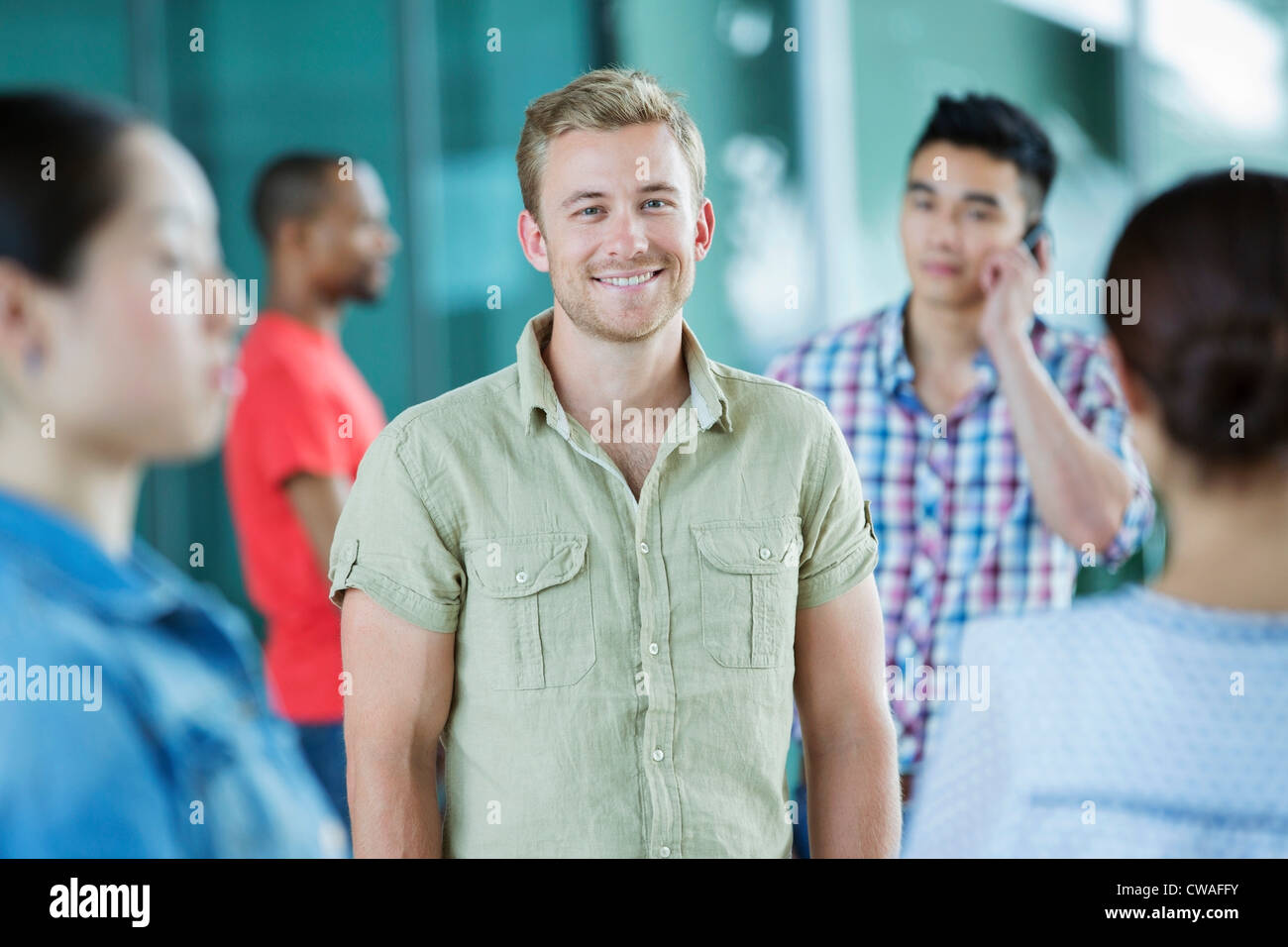 Young man in crowd Stock Photo - Alamy
