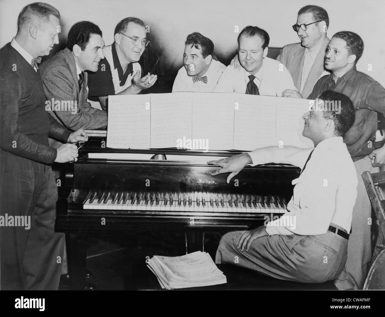 Benny Goodman (1909-86), at rehearsal with his musicians, around piano ...