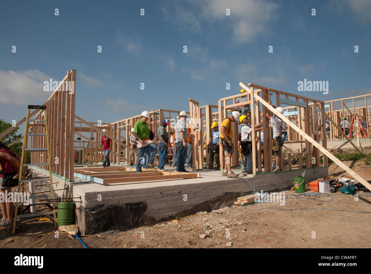 Company employees volunteer their time, help build an affordable house ...