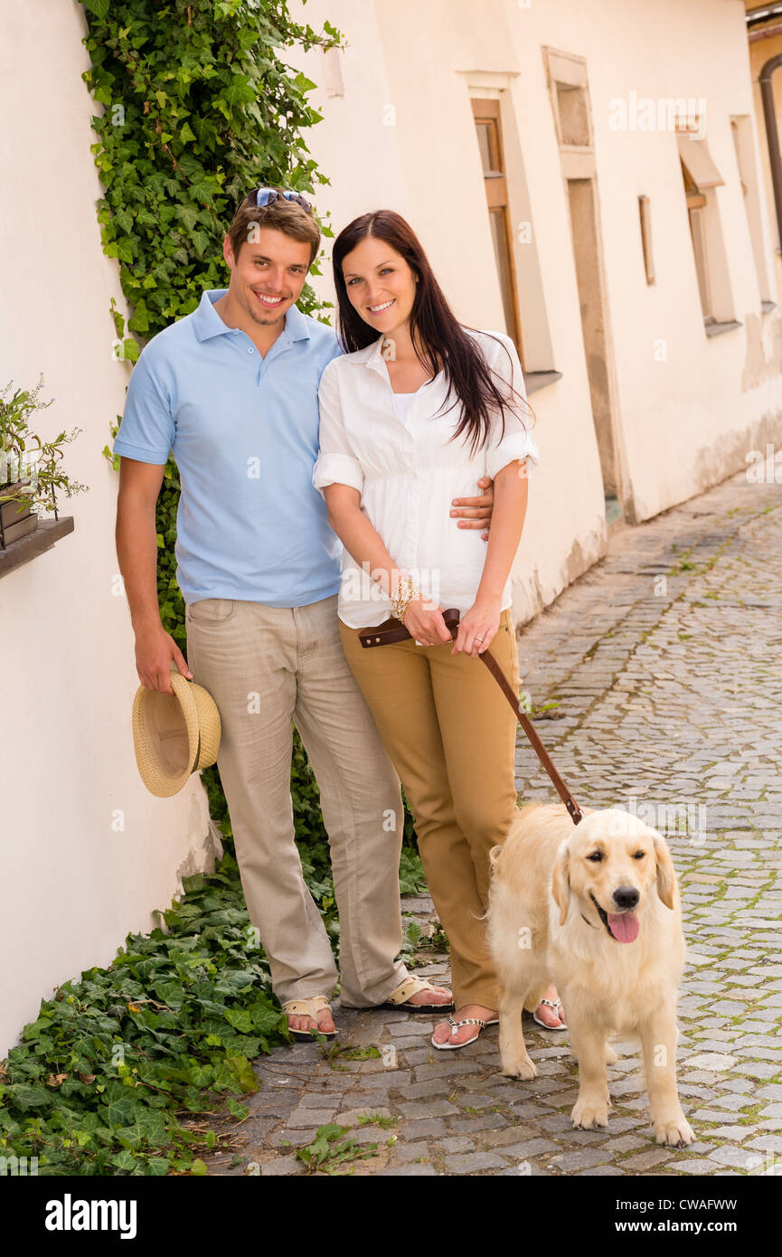 Modern couple with Labrador dog in romantic city smiling together Stock ...