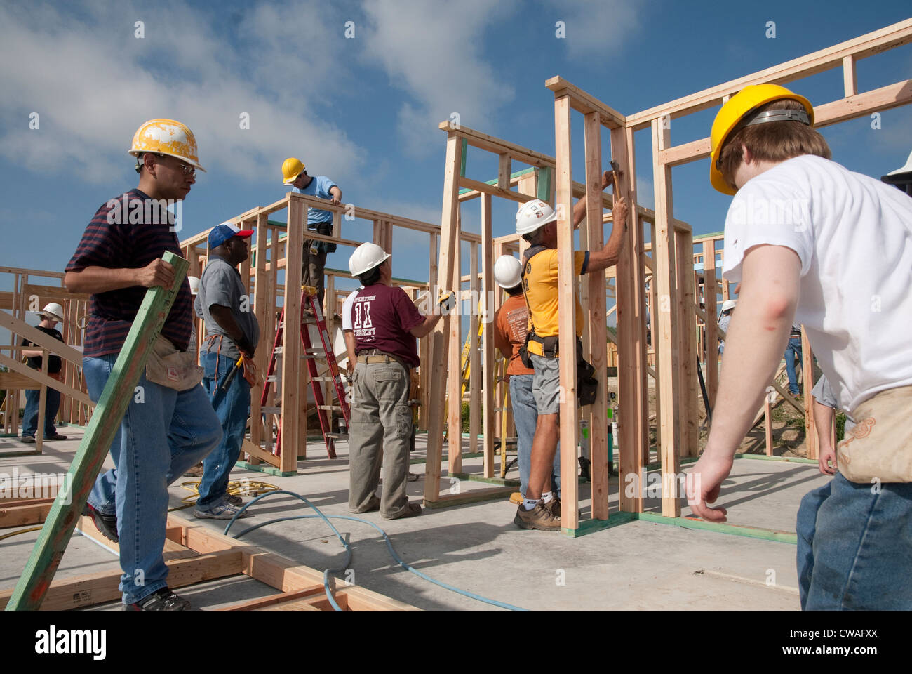 Company employees volunteer their time, help build an affordable house ...