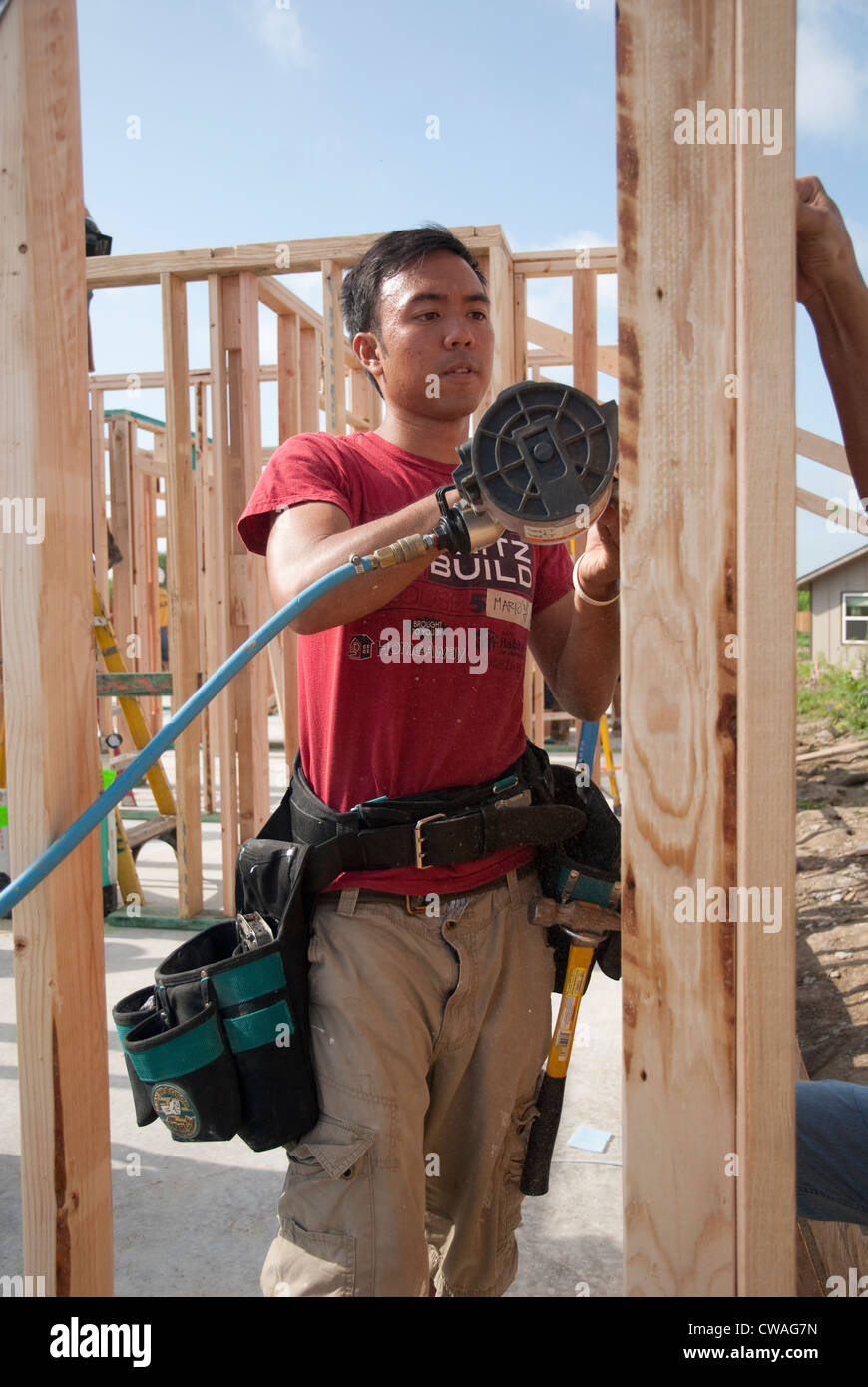 Company employees, Asian male volunteer their time, help build an ...
