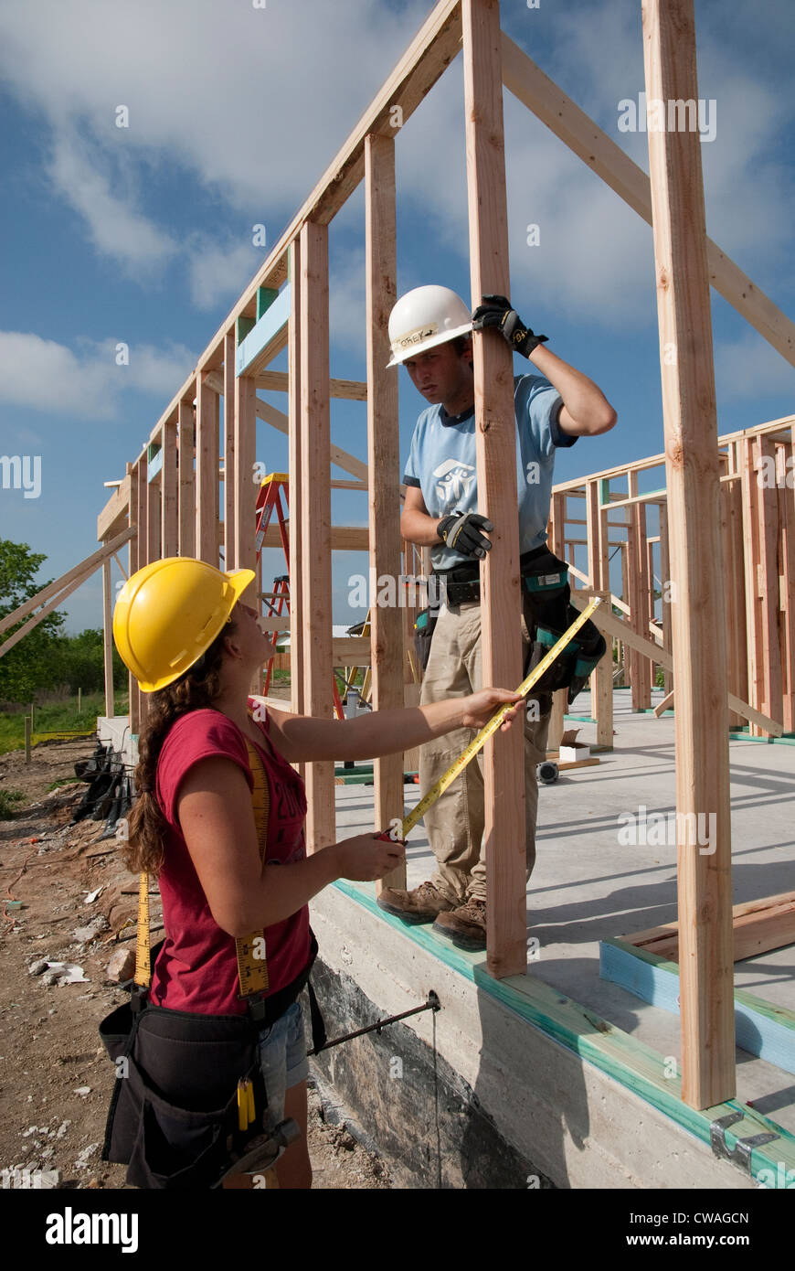 Company employees volunteer their time, help build an affordable house ...