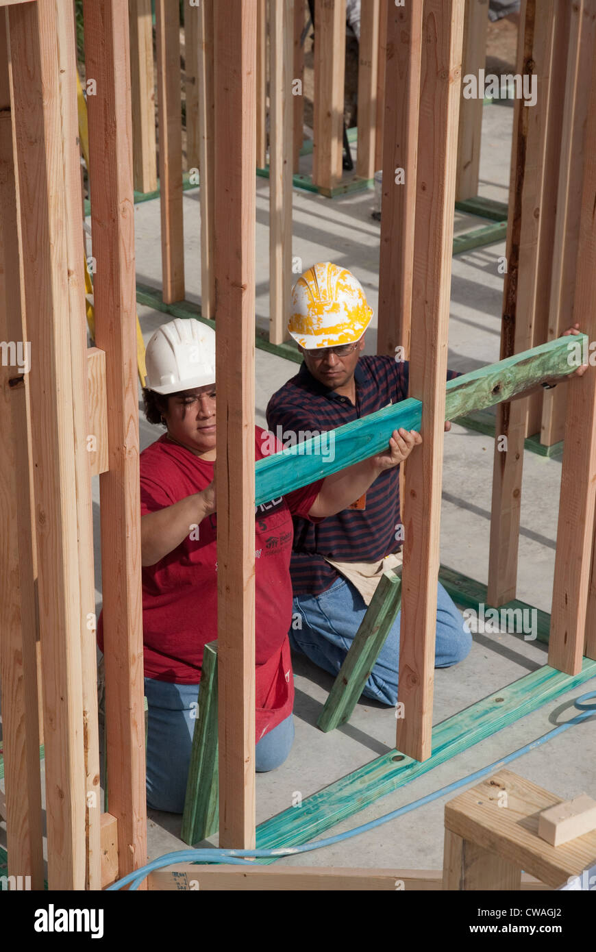 Company employees volunteer their time, help build an affordable house ...