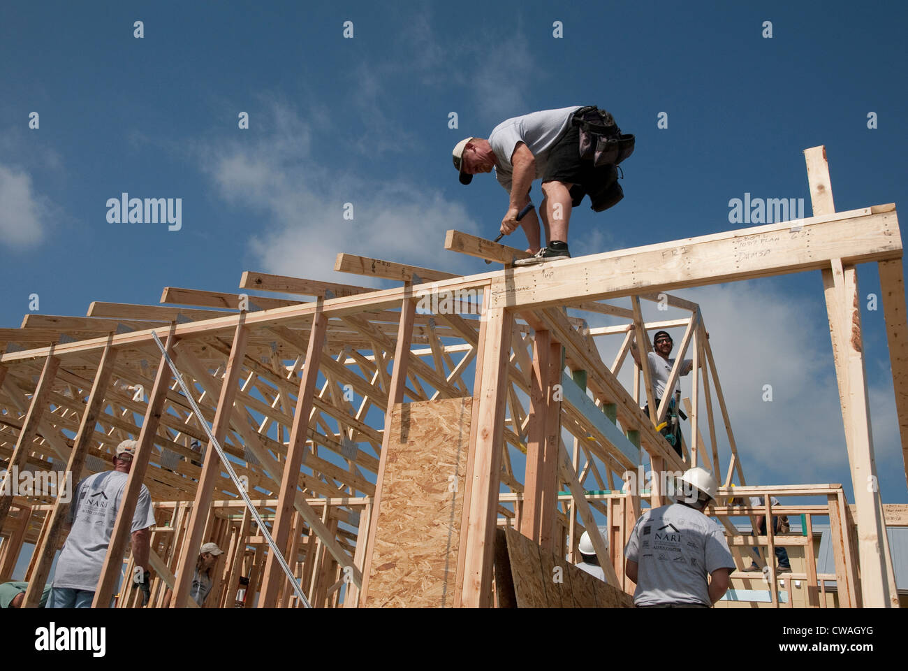 Company employees volunteer their time, help build an affordable house ...