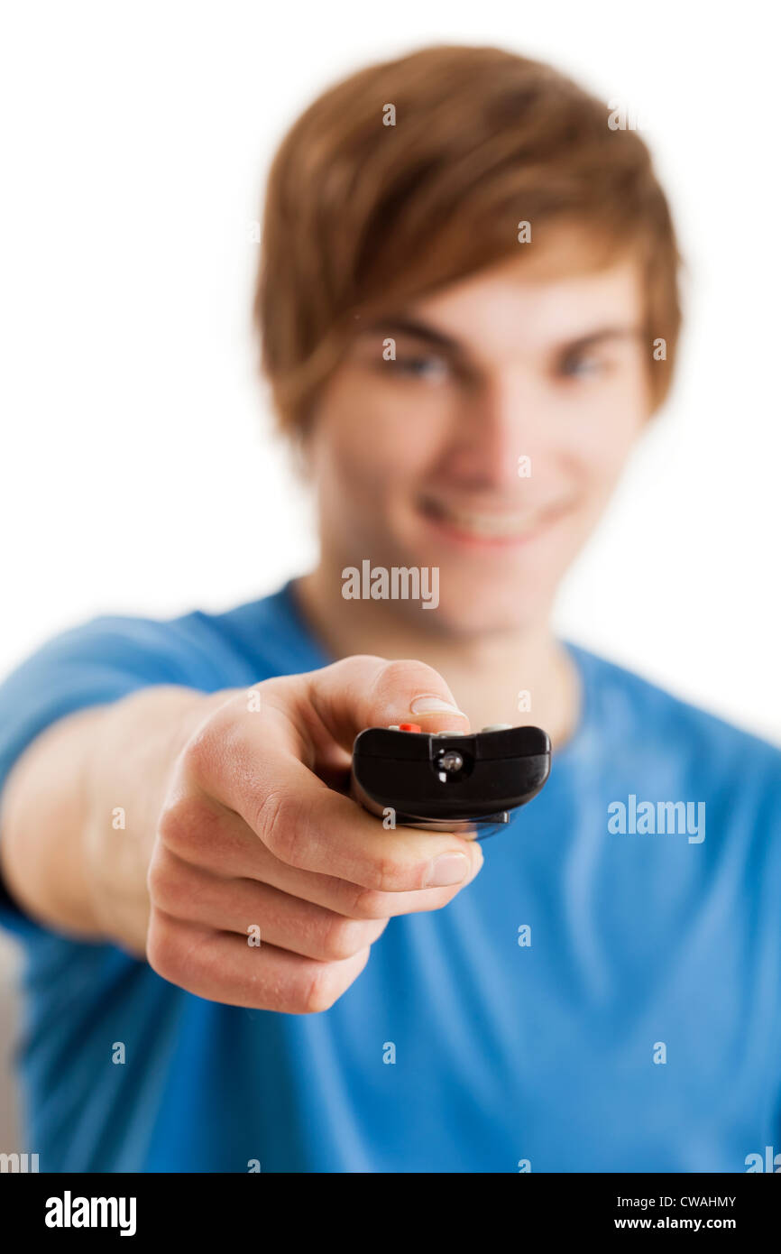 Young man sitting on the couch using a remote control Stock Photo - Alamy