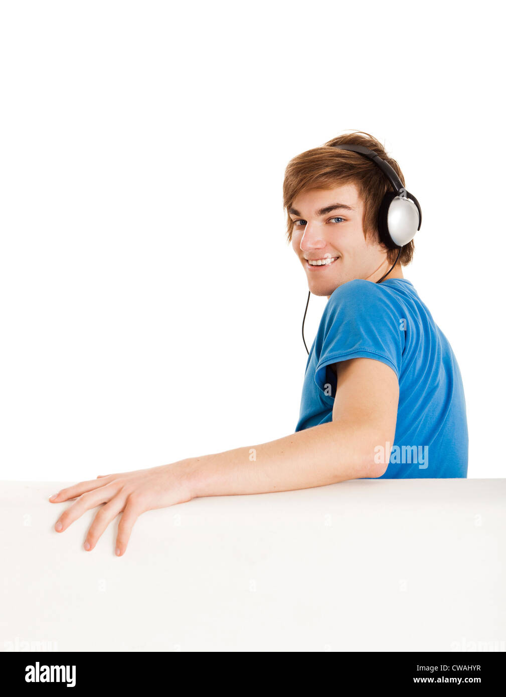 Young man sitting on the couch and listen music, isolated on white ...