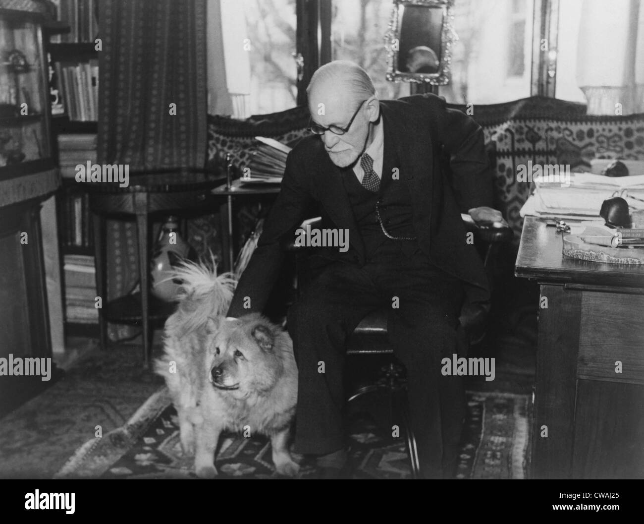 Sigmund Freud (1856-1939), seated in his study with his dog in 1937 ...
