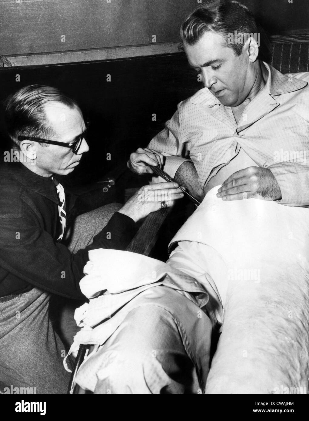 Prop man Bill Sapp screws James Stewart into a plaster cast on the set ...