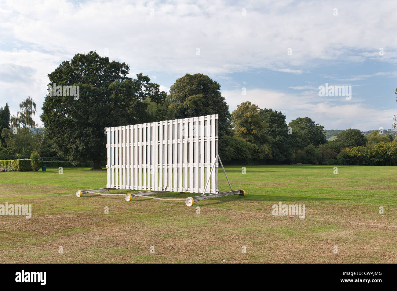 White painted wooden Village cricket sight screen well used on rollers ...