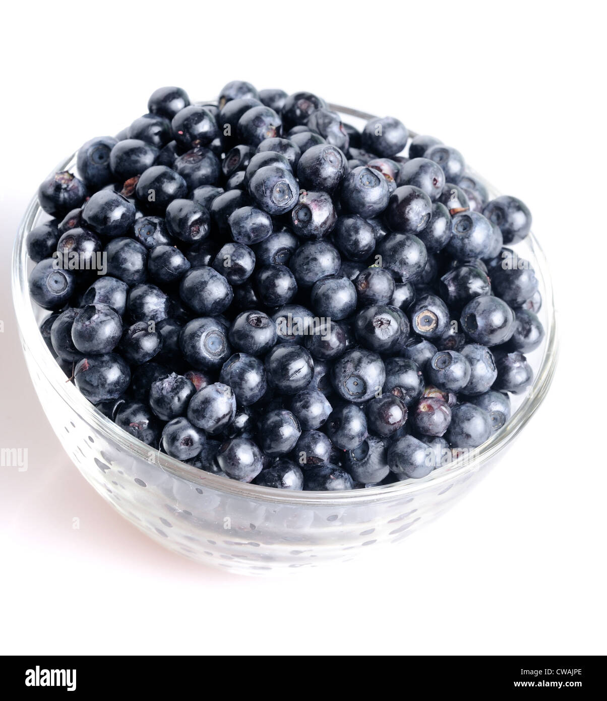 Blueberries in transparent glass dish with soft shadow on white ...