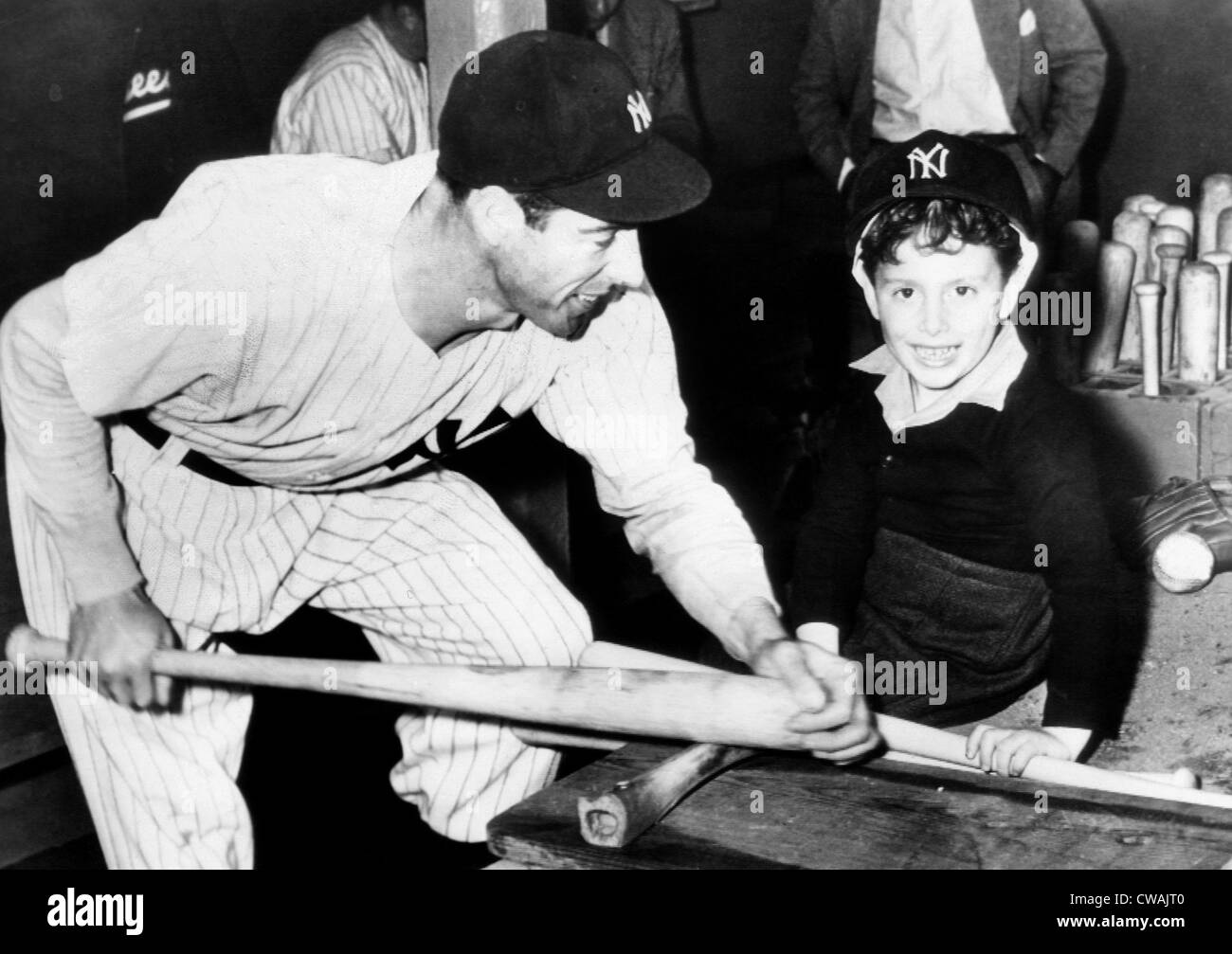 Joe DiMaggio shows his son, Joe Jr., how to bone down a baseball bat ...