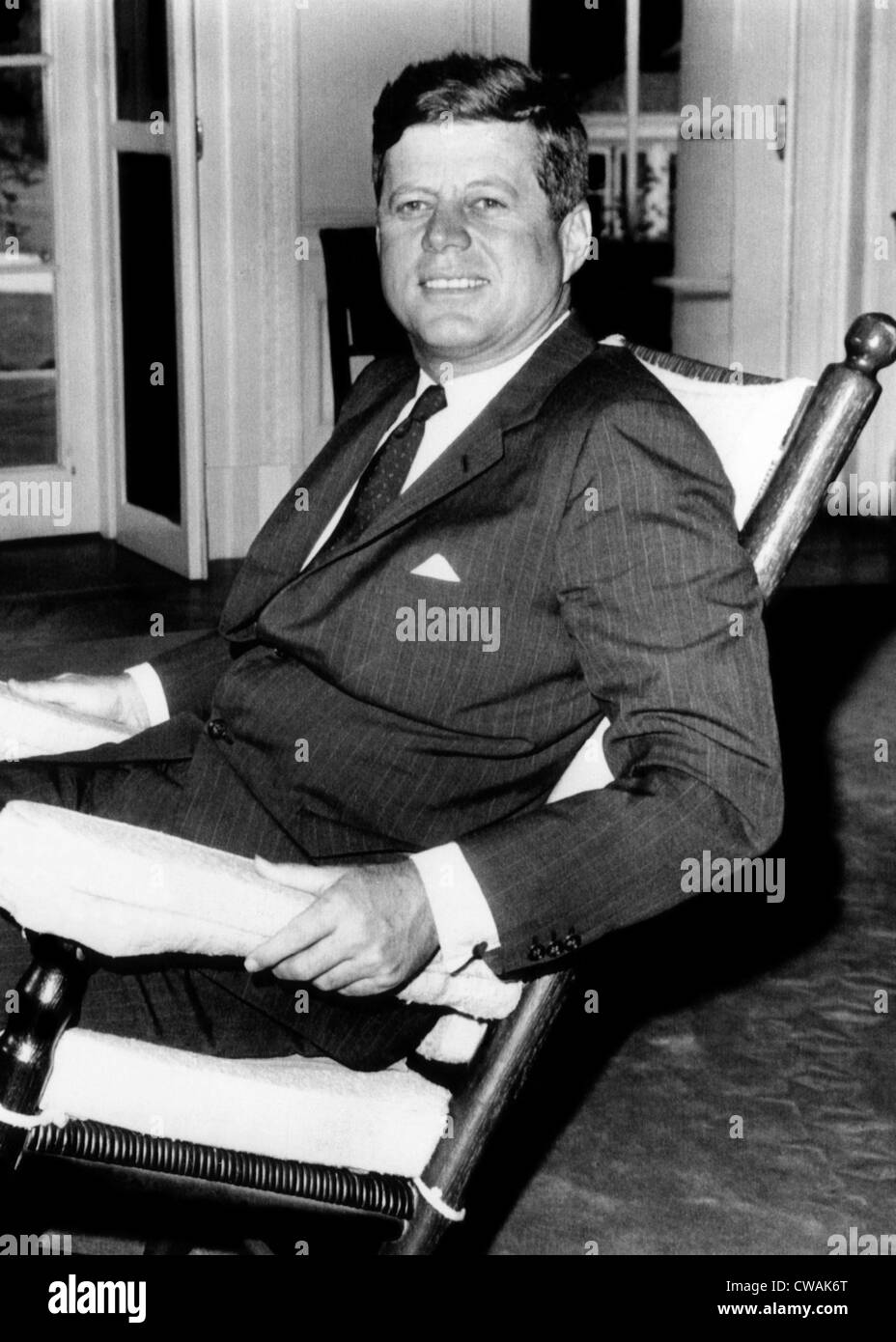 John F. Kennedy, relaxes in his rocking chair on the eve of his 45th ...