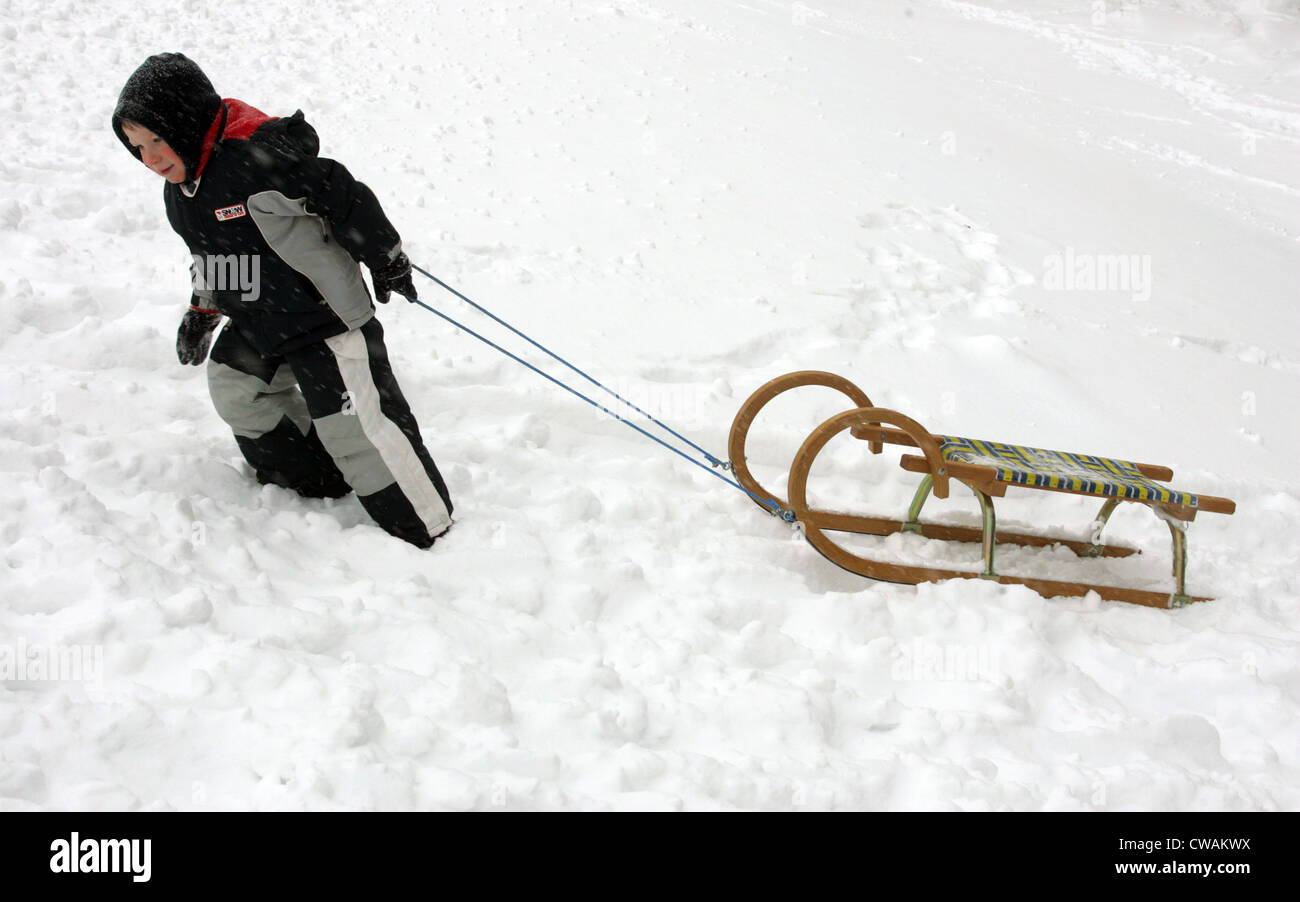 Child pulling sled up hill hi-res stock photography and images - Alamy