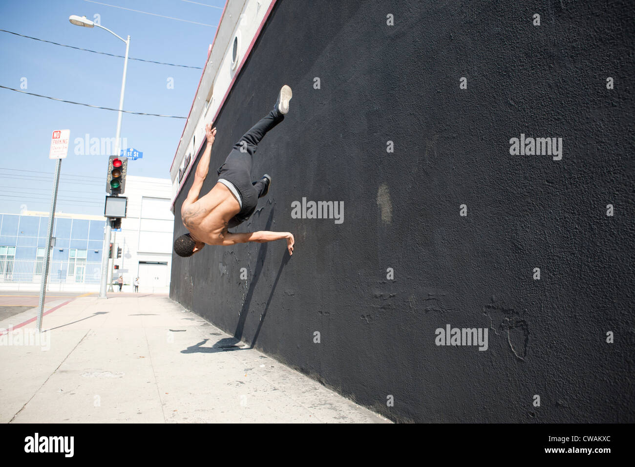 Man running up wall, demonstrating parkour Stock Photo - Alamy