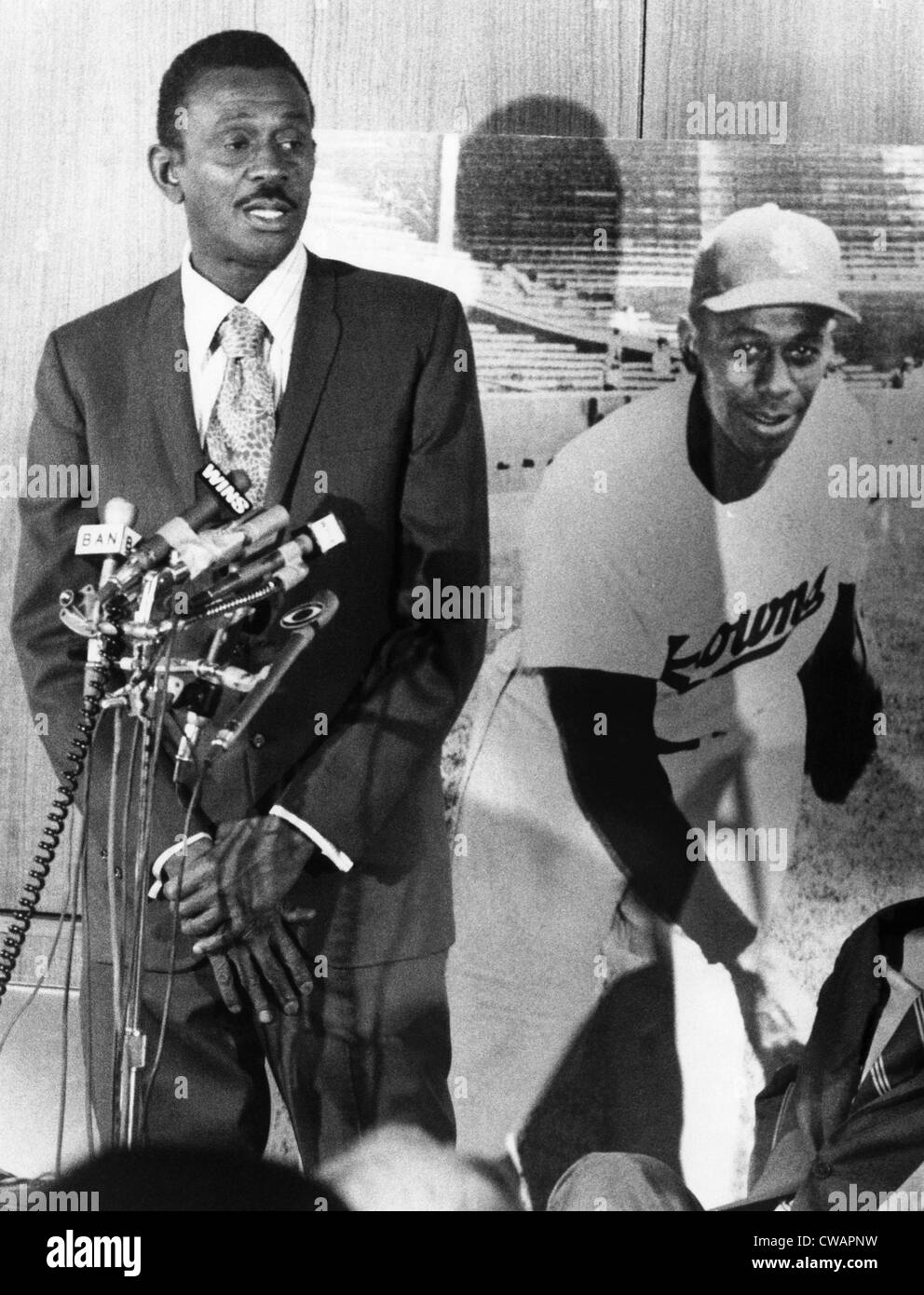 Pitcher Leroy 'Satchel' Paige (1906-1982), standing beside a picture of ...