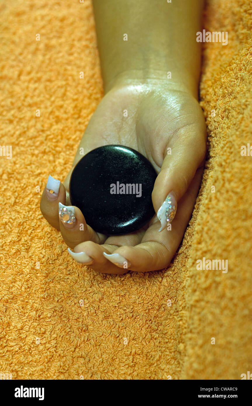 Photo of young woman using stone massage Stock Photo - Alamy