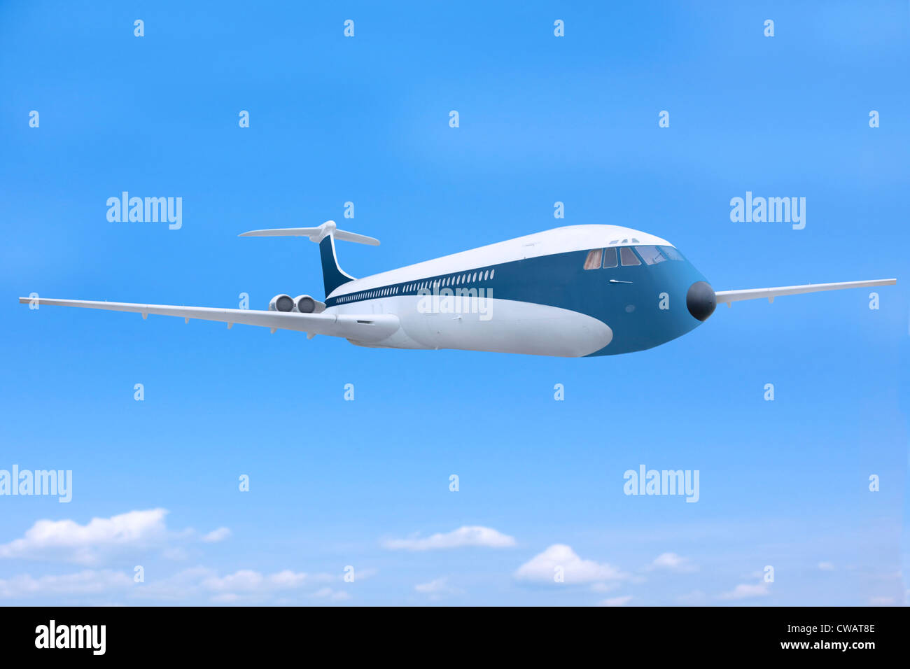 generic aeroplane mid flight against a blue sky Stock Photo - Alamy