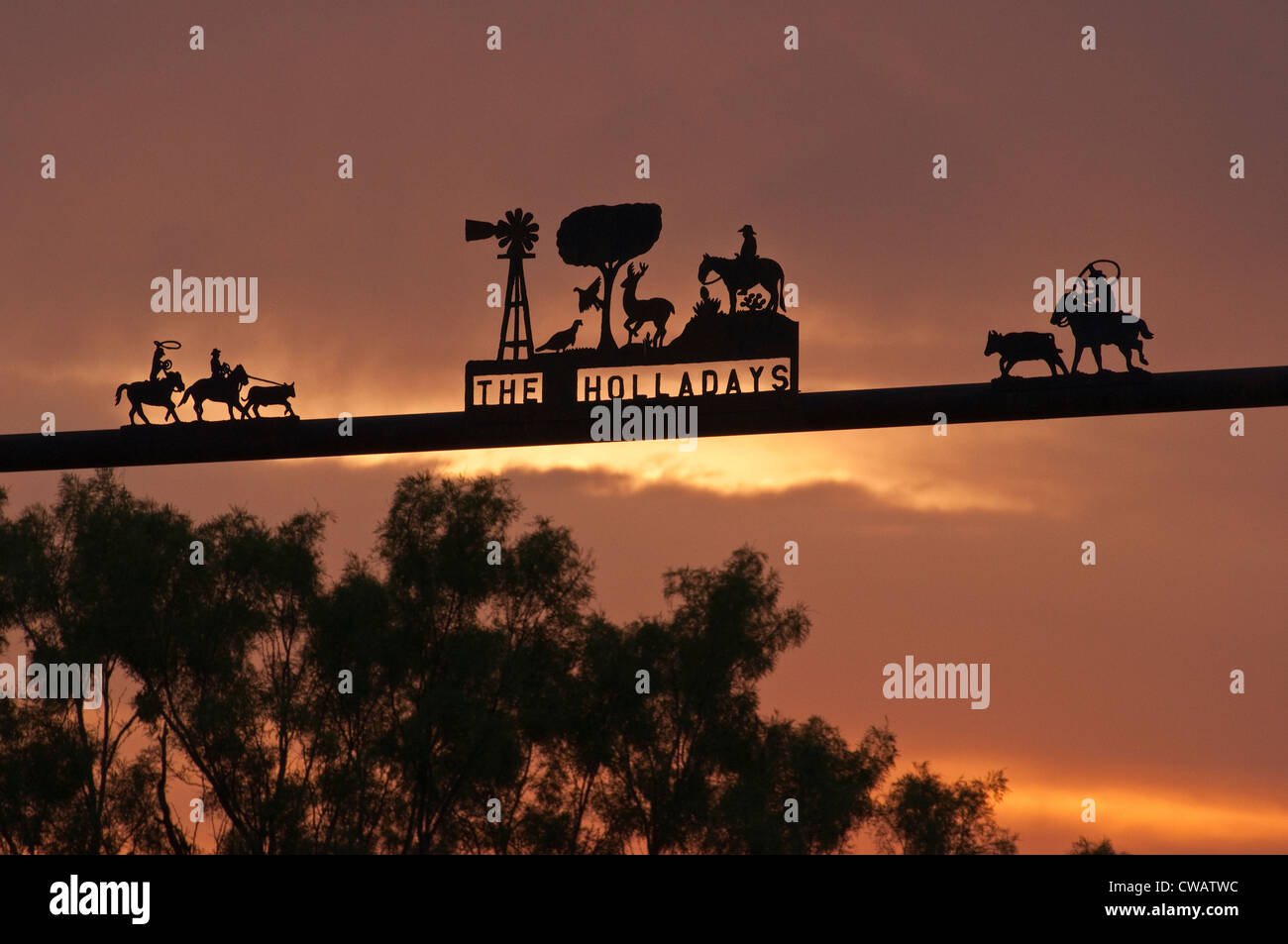 Wrought iron signs at ranch gate at sunrise near San Angelo, Tom Green ...