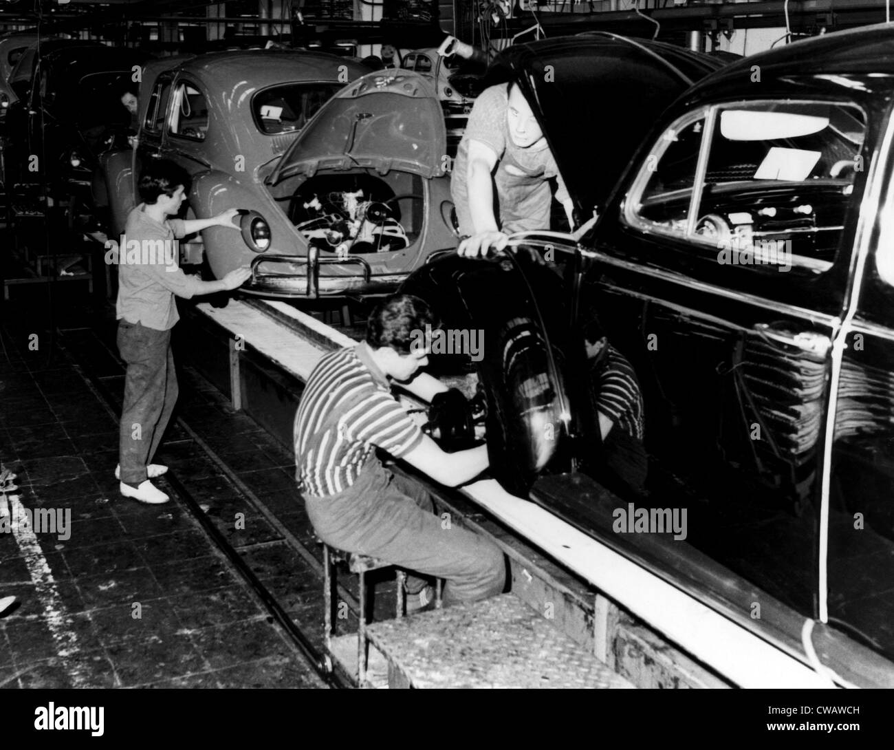 Men work on the assembly line at a Volkwagen factory, 1963. Courtesy ...
