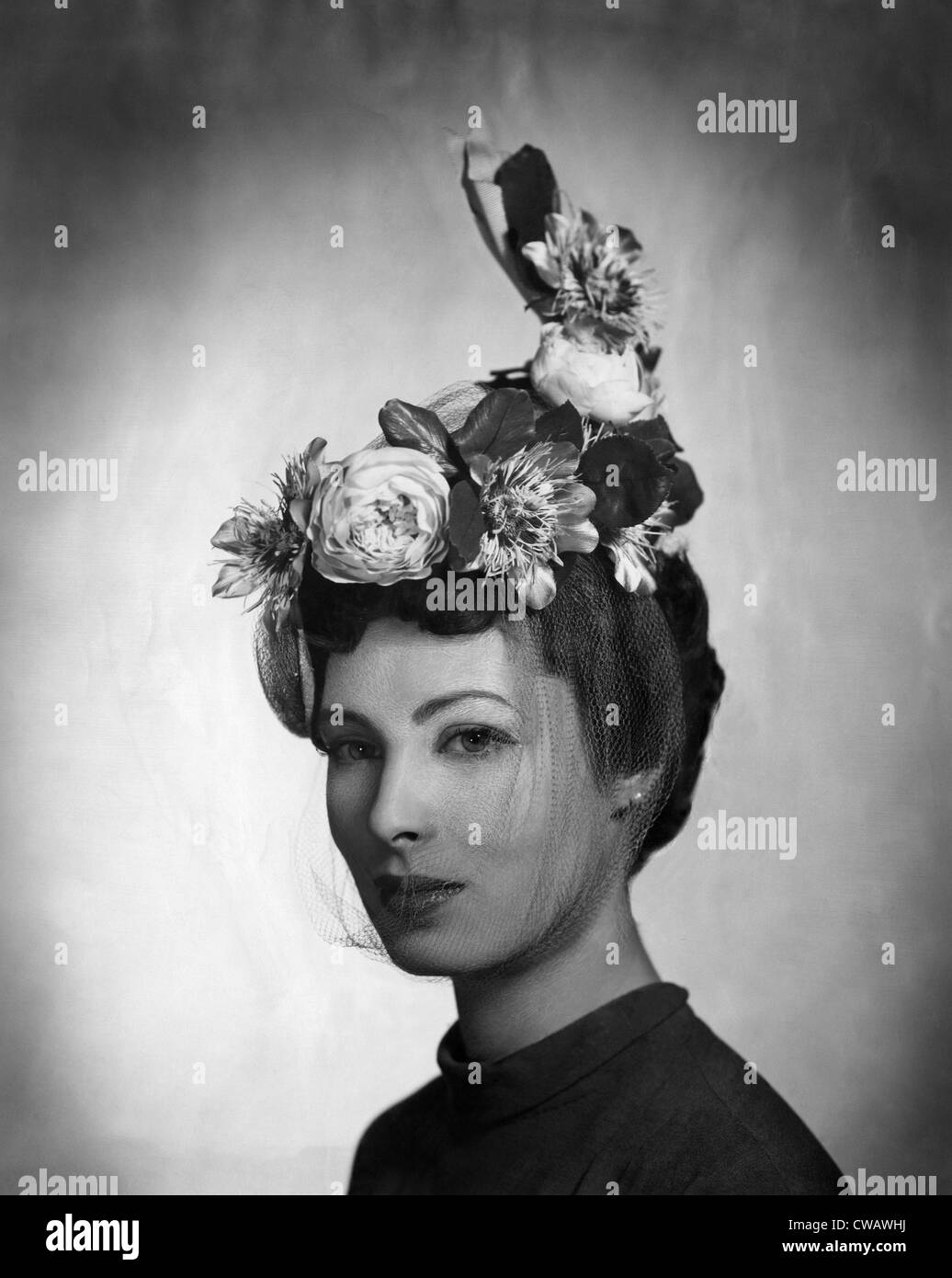 A model wearing a hat by Lilly Dache made of gray linen straw with ...