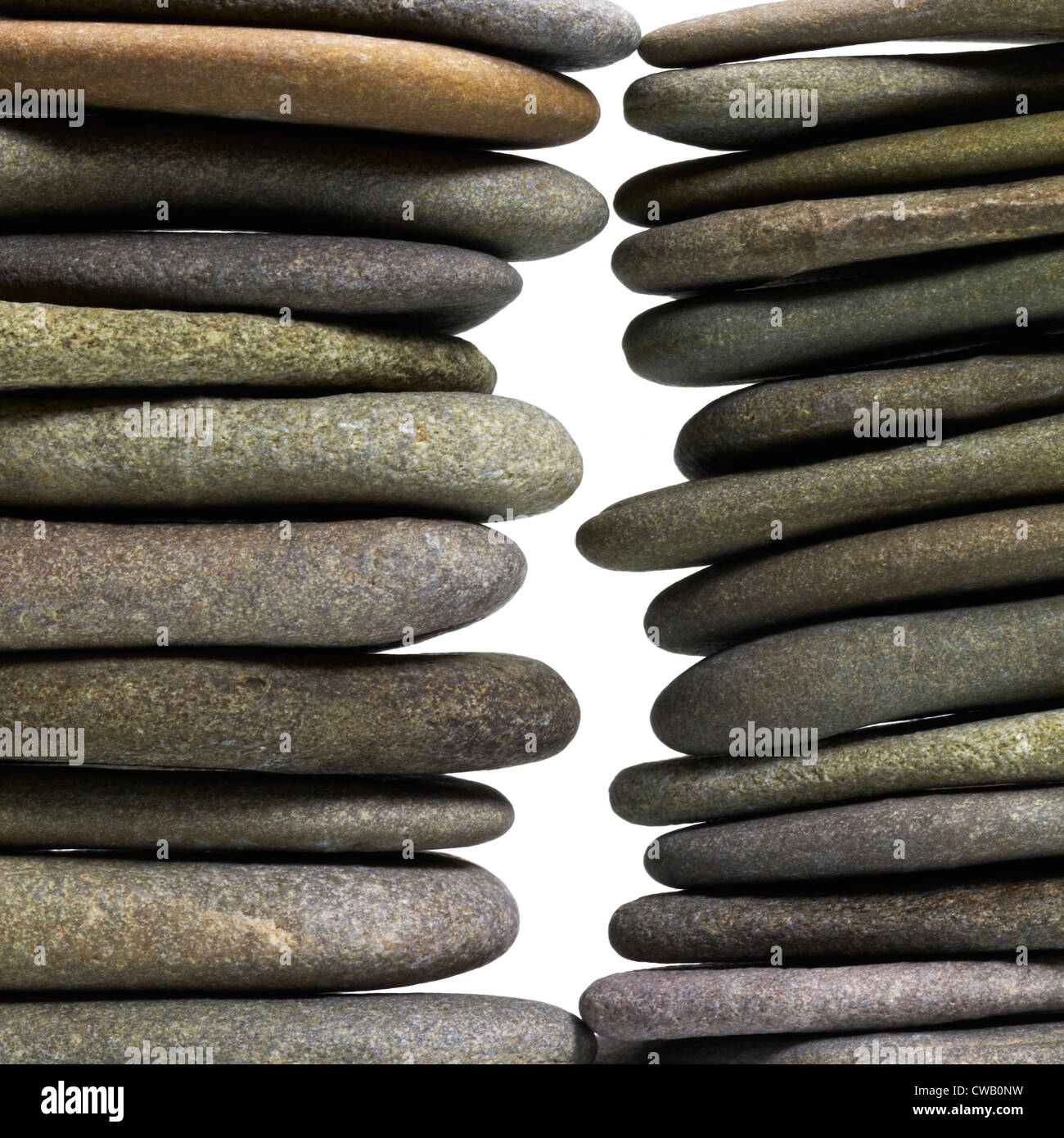 low angle view of two flat pebble stone stacks in light back Stock ...