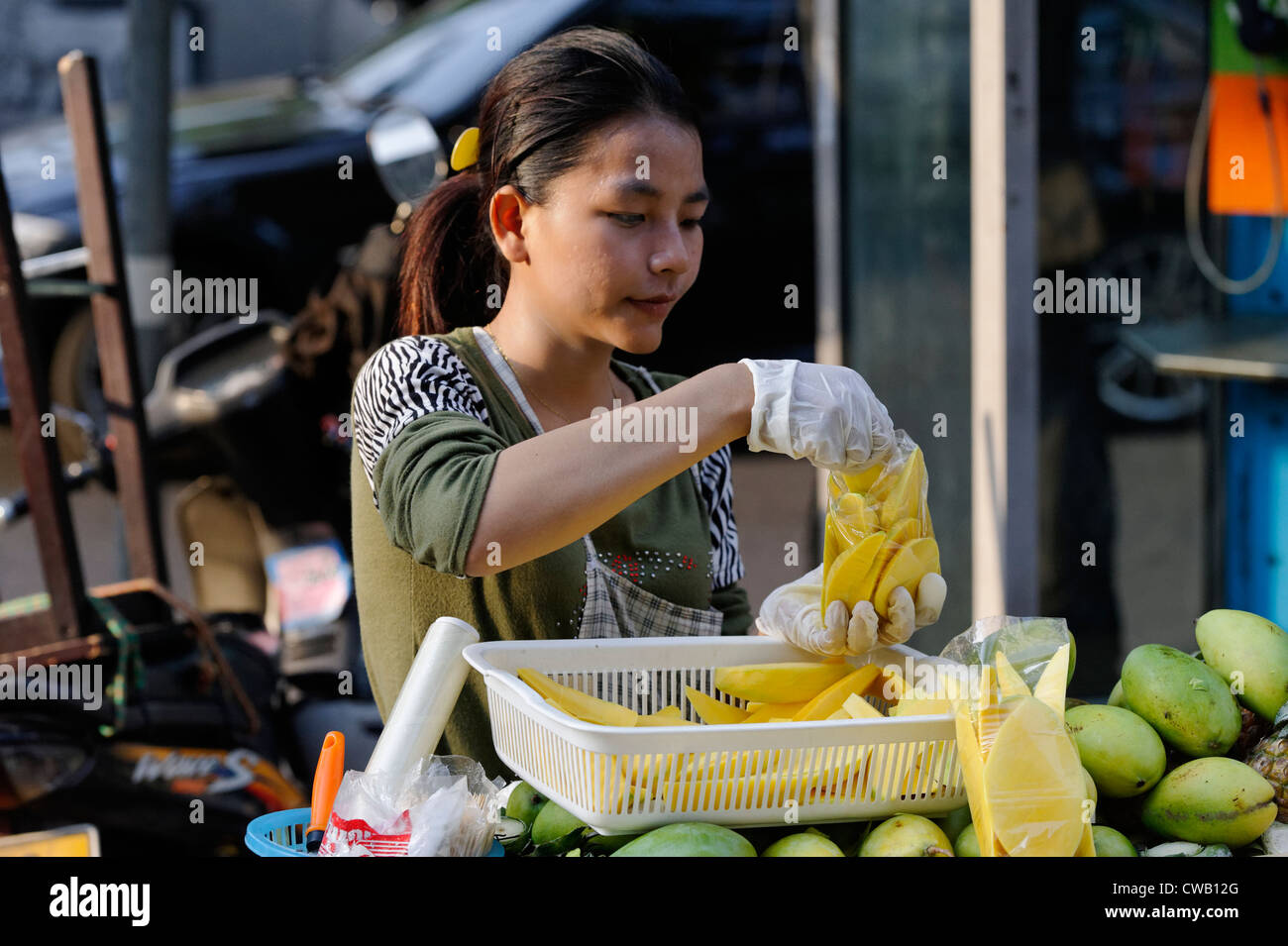 Woman working on a hawker stall selling food on the streets of bangkok ...