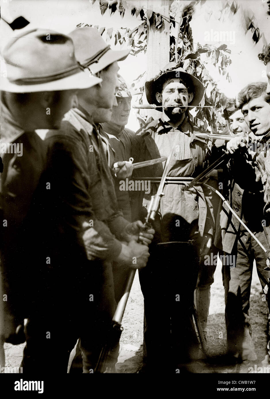 World War I, soldiers haze a new militiaman with knives at Fort ...