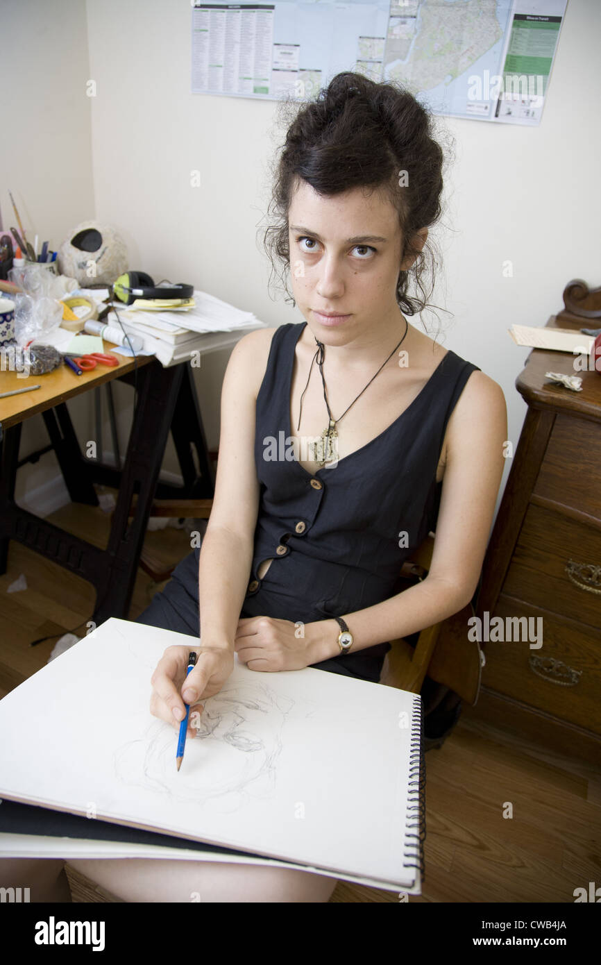 Young artist sketching someone in her studio in Brooklyn, NY Stock ...