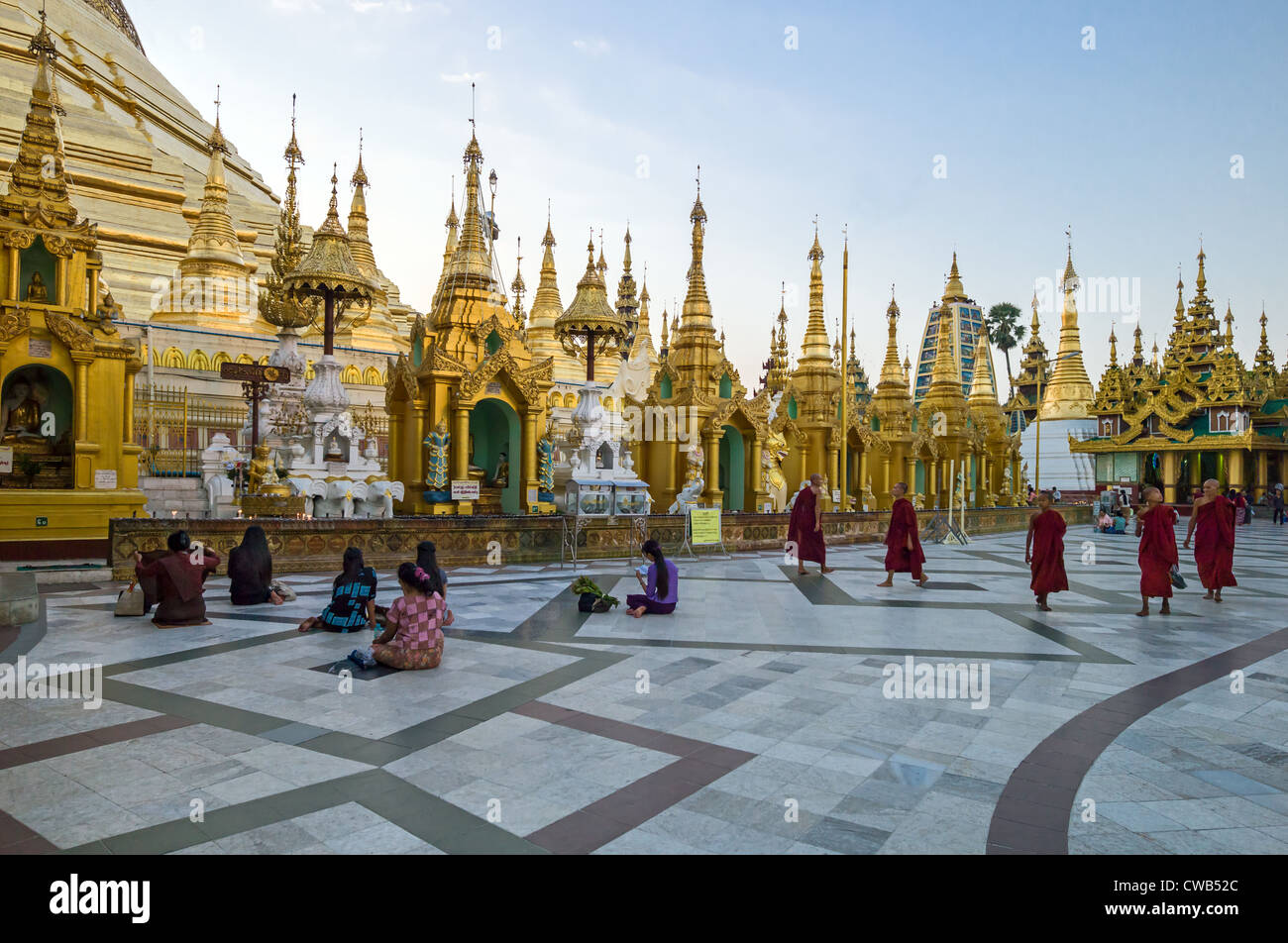 Myanmar, Yangon, religious in prayer and monks in the Swedagon Pagoda ...