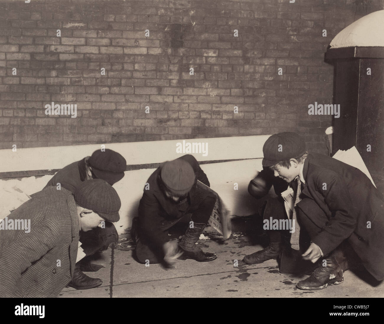 Children playing a dice game, from original caption: 'playing craps in ...